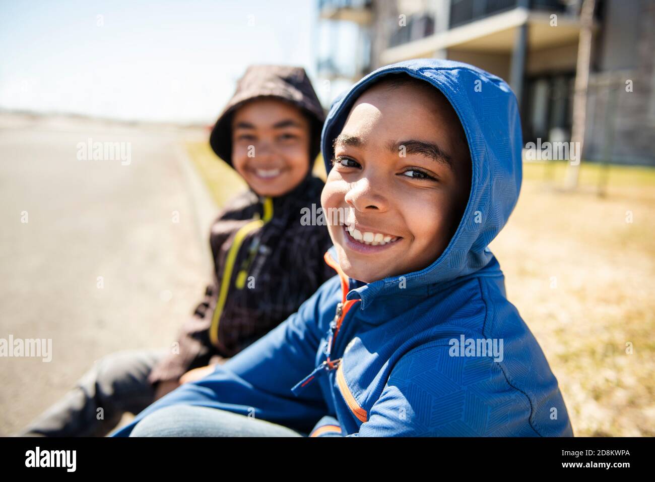 The Children Smiling outside in spring season with coat Stock Photo - Alamy