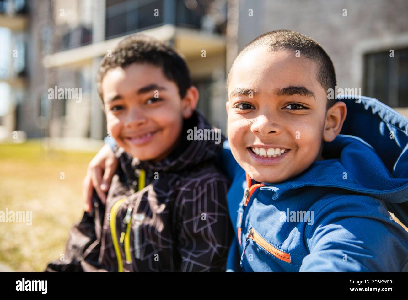 The Children Smiling outside in spring season with coat Stock Photo - Alamy