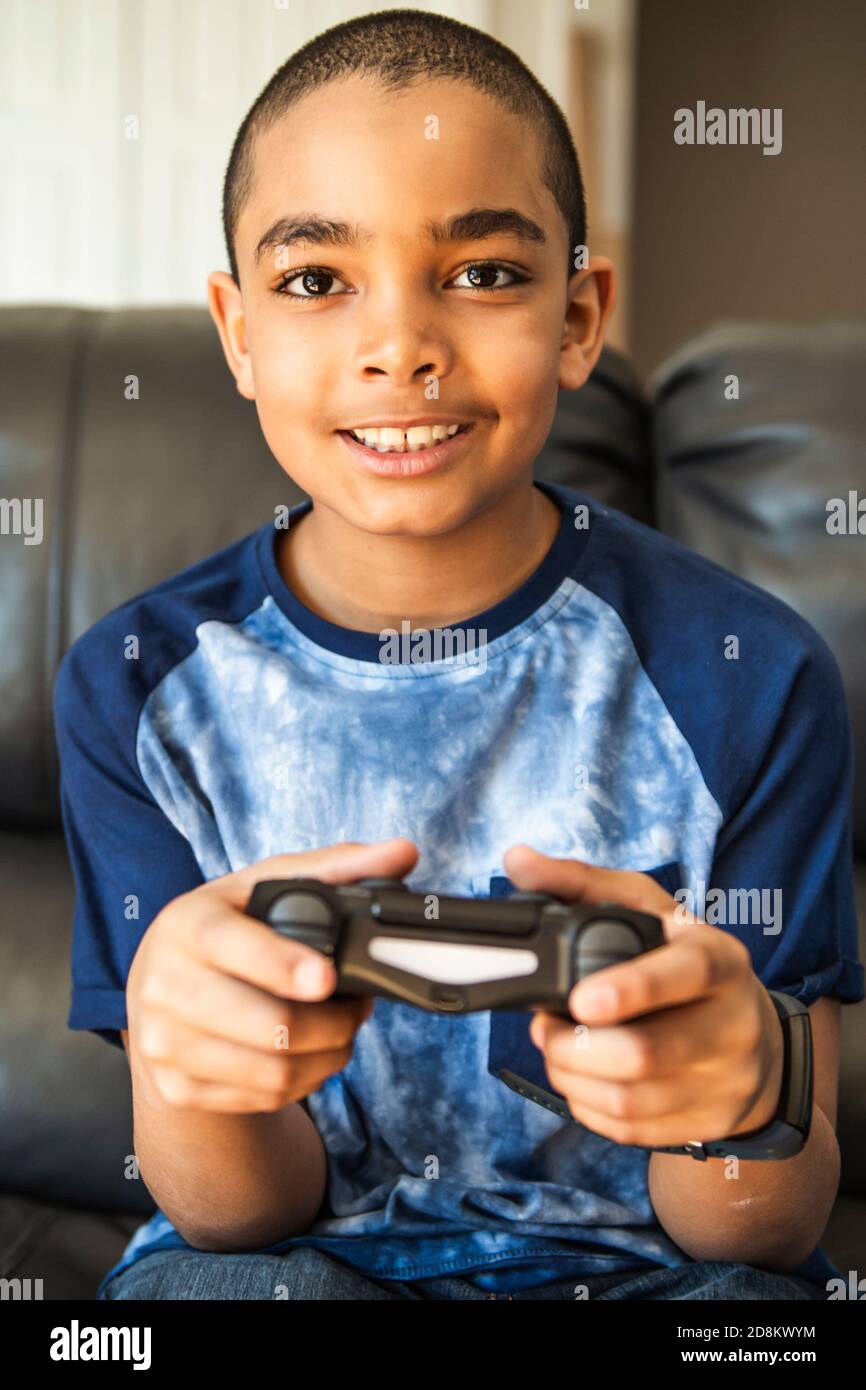 Young boy playing video game, at home Stock Photo - Alamy