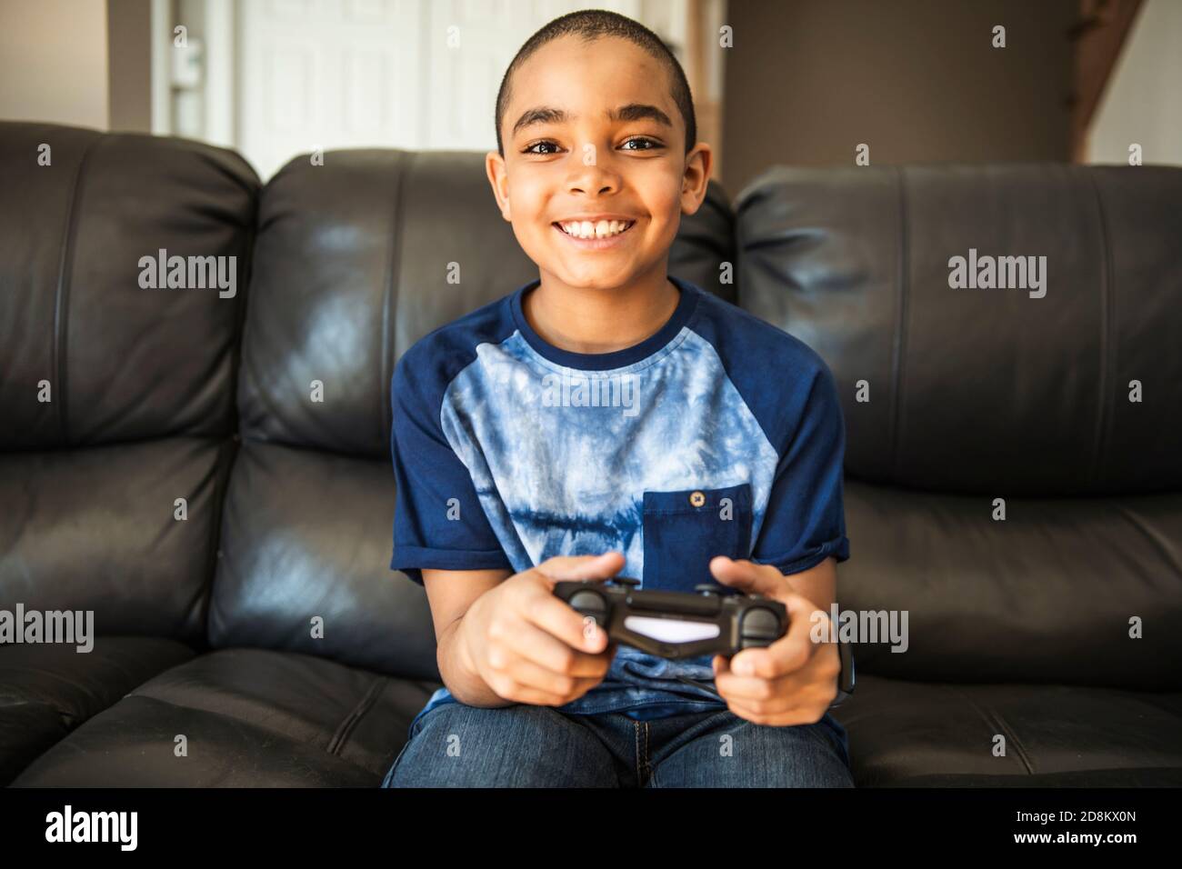 Young boy playing video game, at home Stock Photo - Alamy