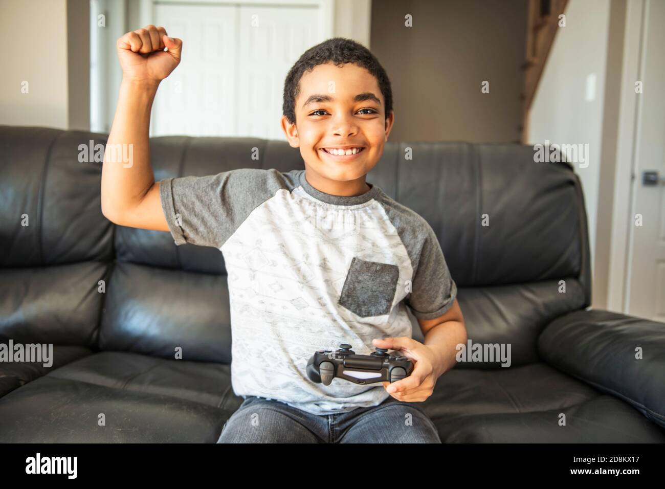 Young boy playing video game, at home Stock Photo - Alamy