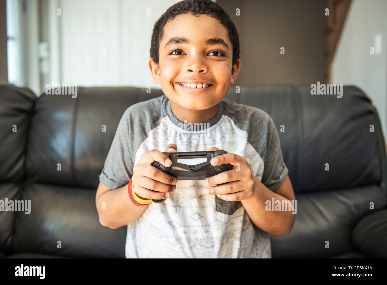 Young boy playing video game, at home Stock Photo - Alamy