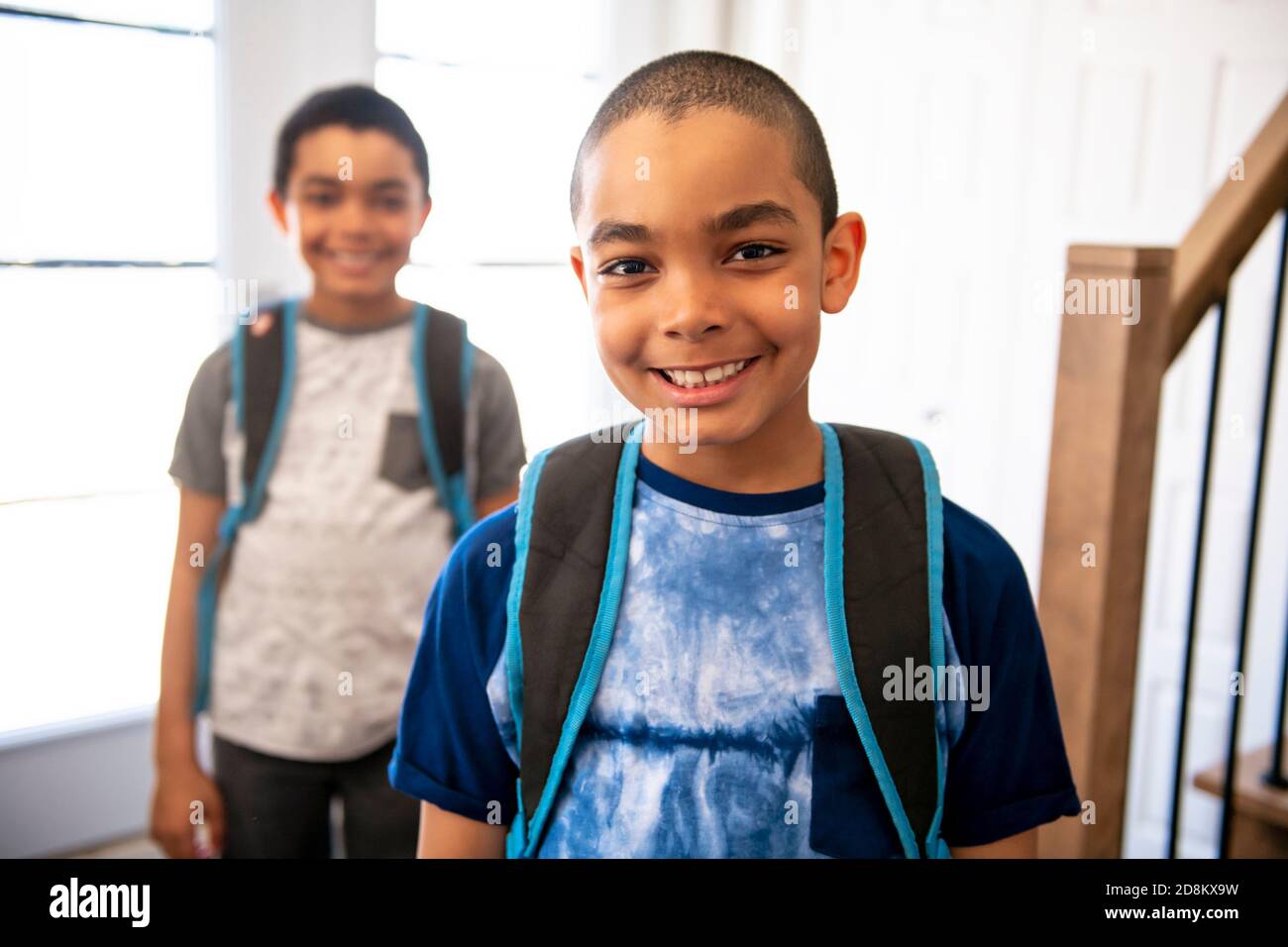 A child boy coming home passing through the door after school Stock ...