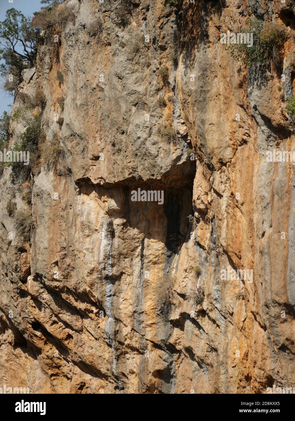Vertical shot of the huge cliffs captured in Crete, Greece during the ...