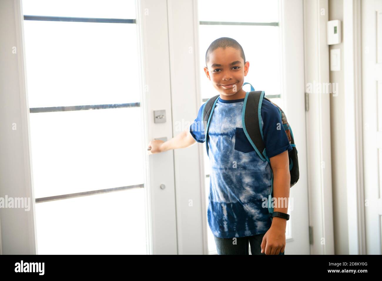 A child boy coming home passing through the door after school Stock ...