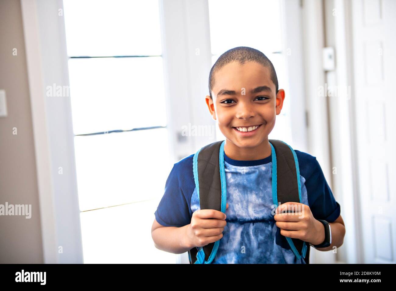 A child boy coming home passing through the door after school Stock ...