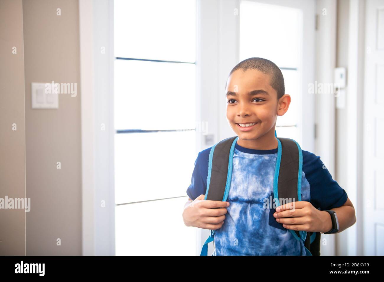 A child boy coming home passing through the door after school Stock ...