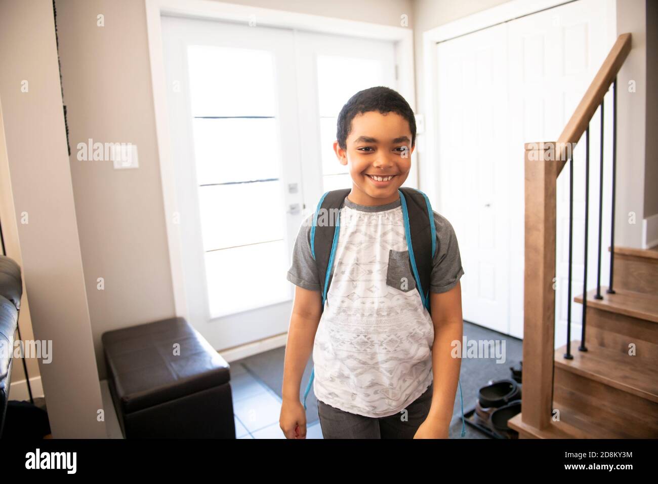 A child boy coming home passing through the door after school Stock ...
