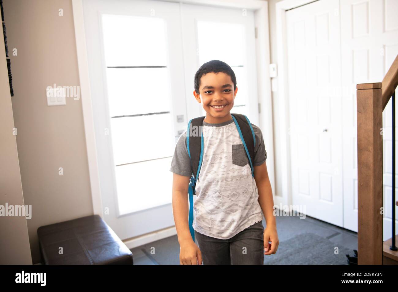 A child boy coming home passing through the door after school Stock ...