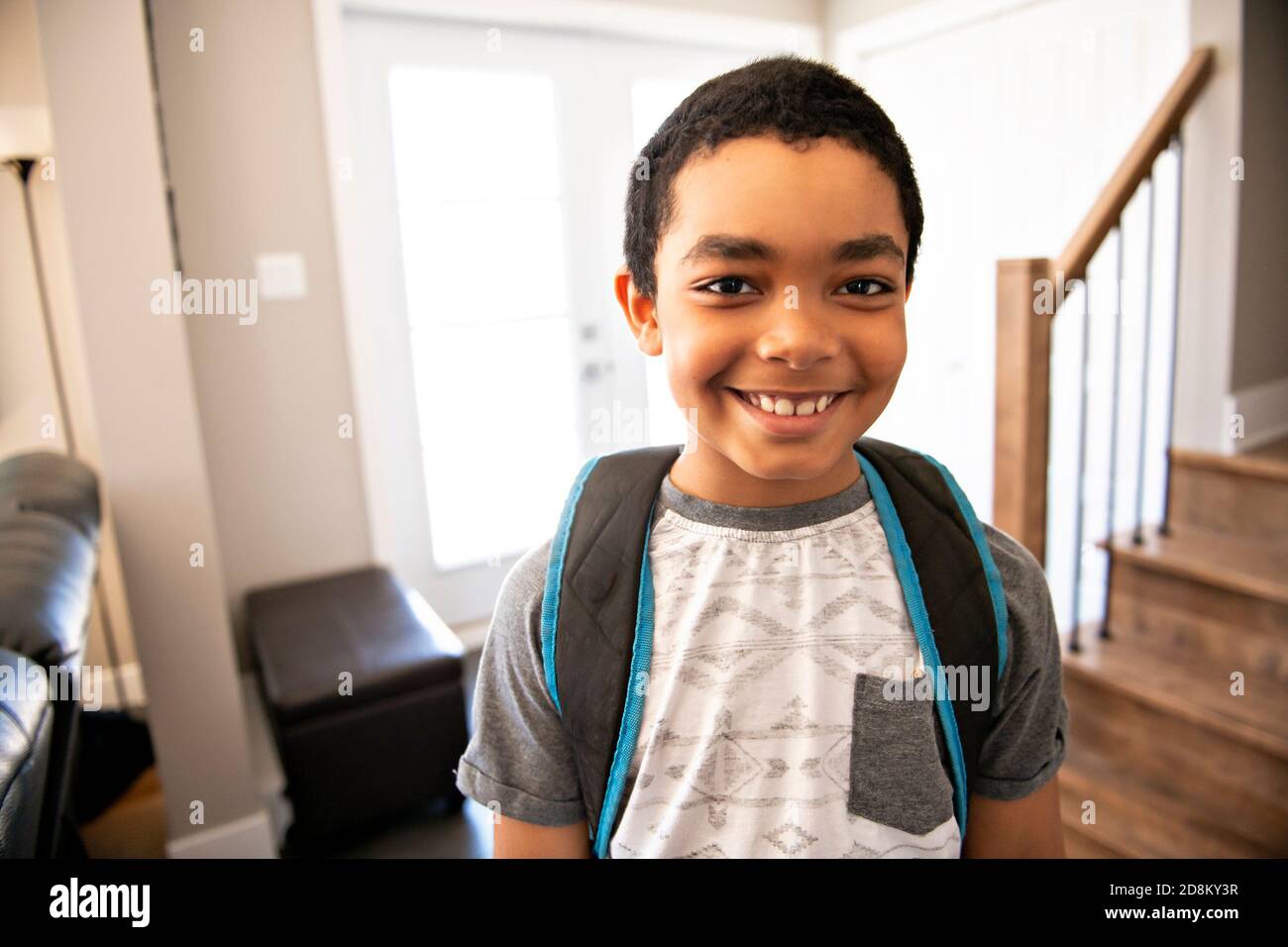 A child boy coming home passing through the door after school Stock ...