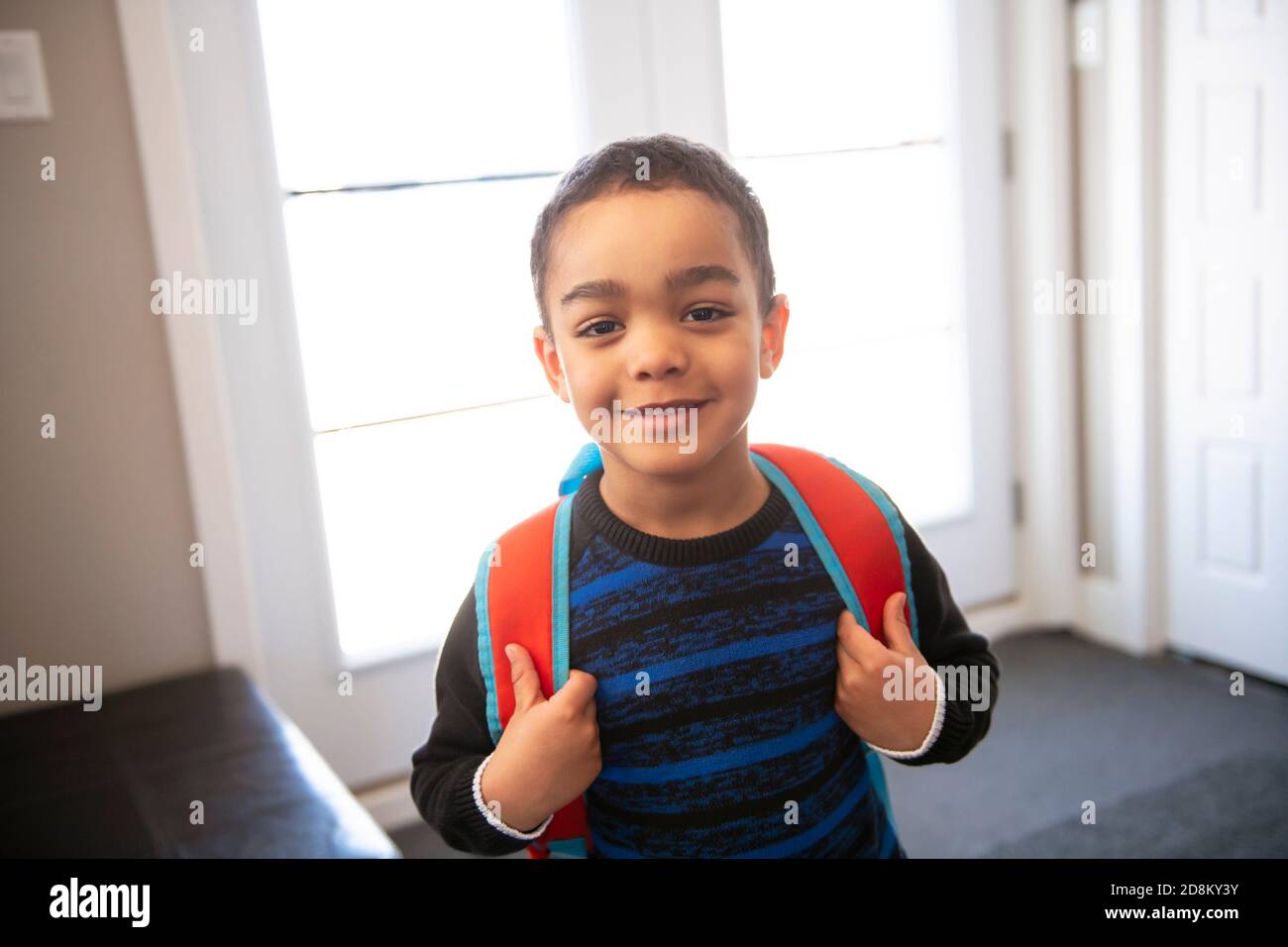 A child boy coming home passing through the door after school Stock ...
