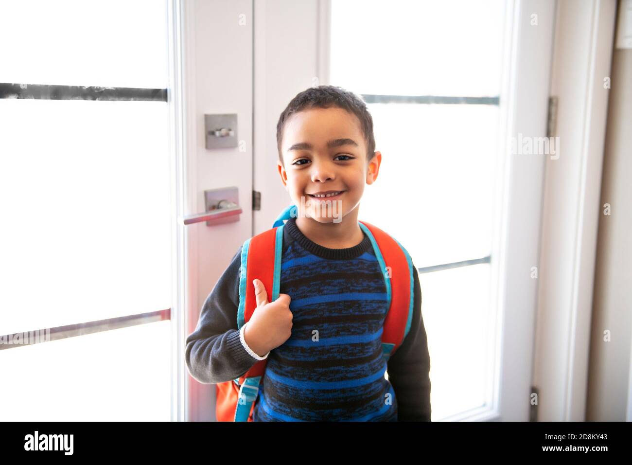 A child boy coming home passing through the door after school Stock ...