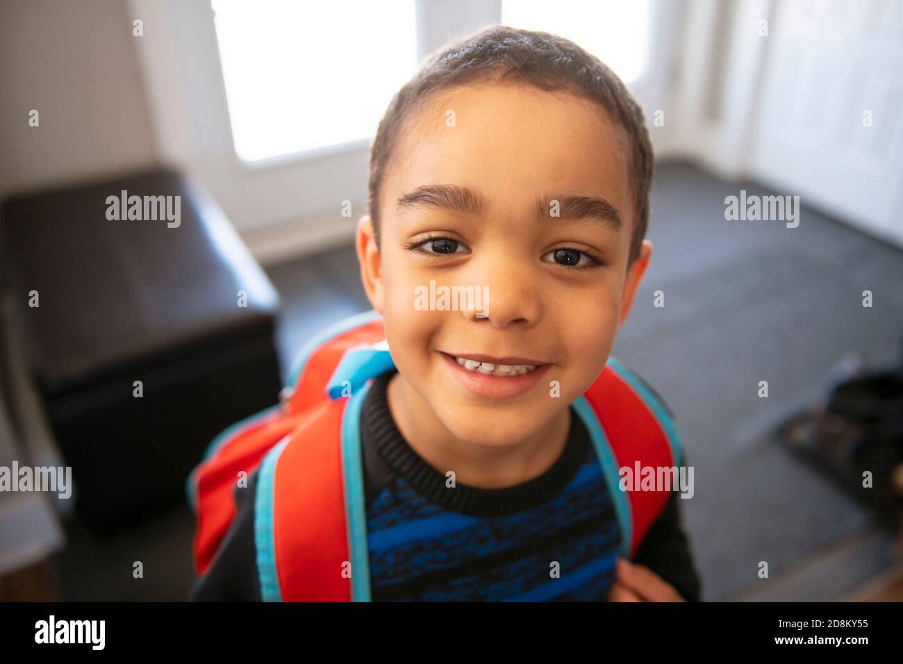 A child boy coming home passing through the door after school Stock ...