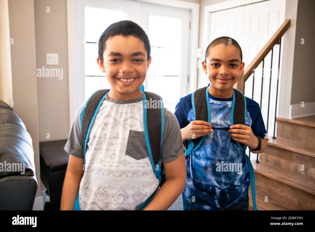A child boy coming home passing through the door after school Stock ...