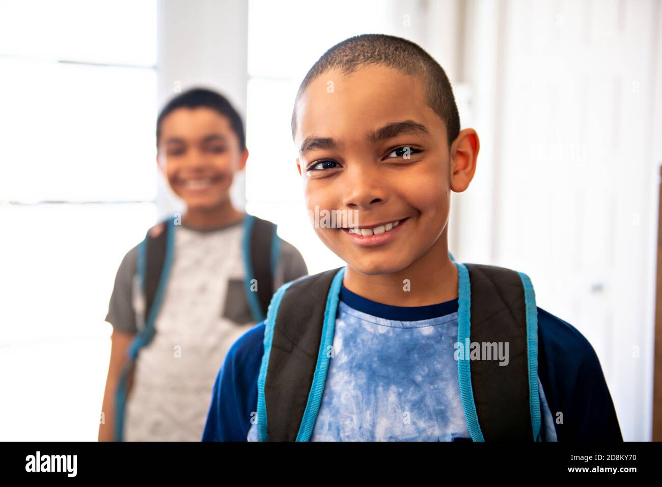 A child boy coming home passing through the door after school Stock ...
