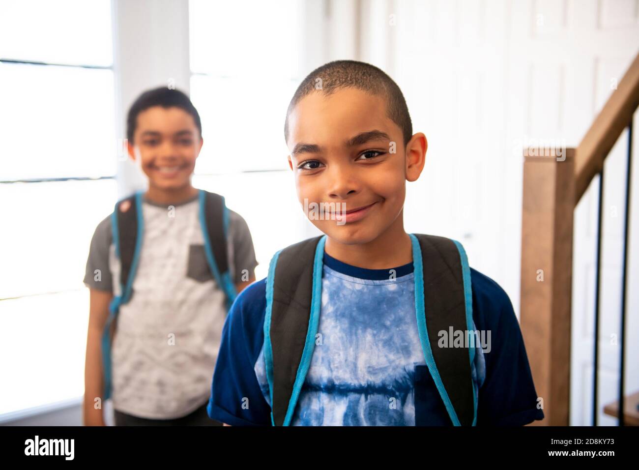 A child boy coming home passing through the door after school Stock ...