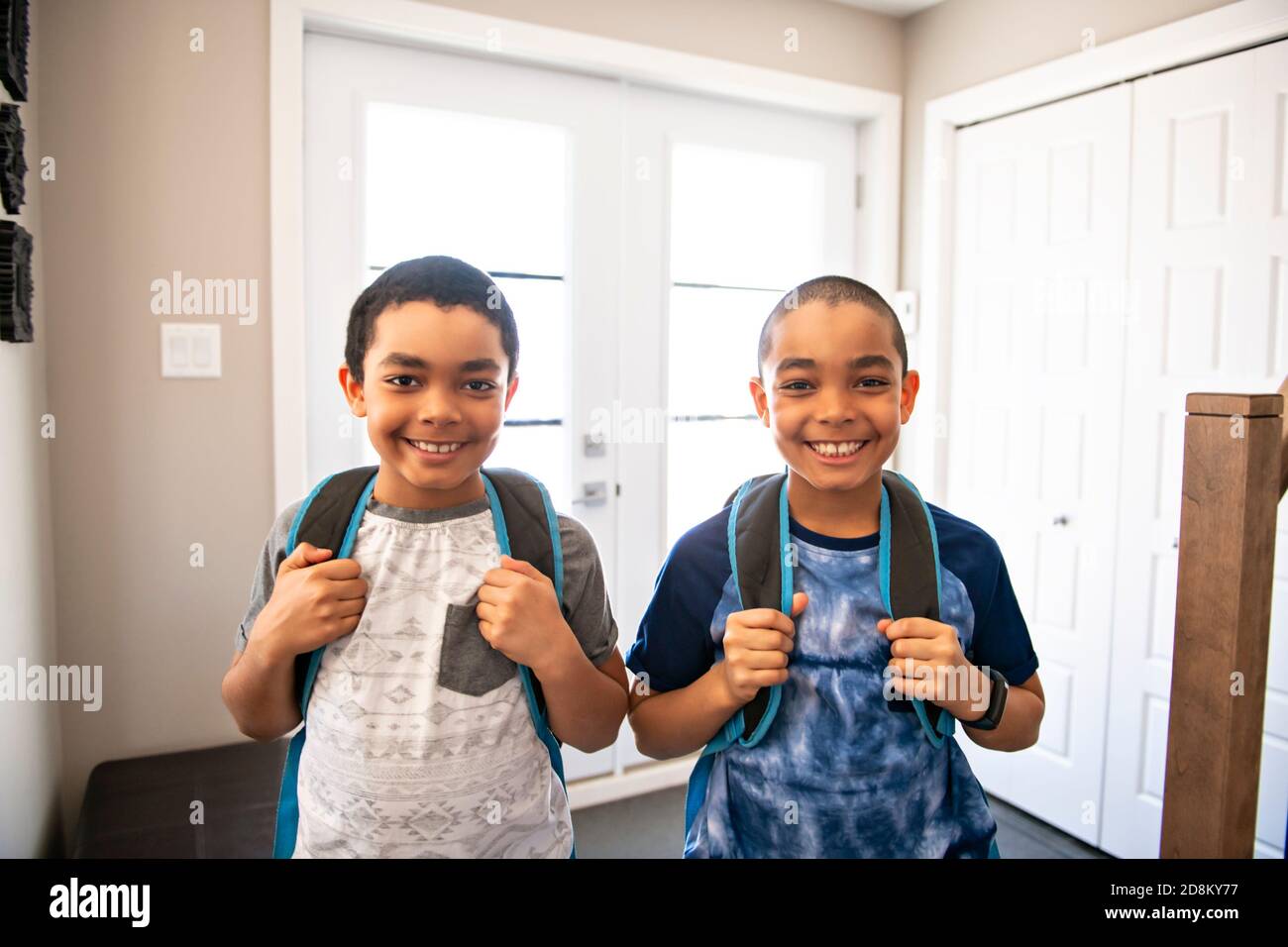 A child boy coming home passing through the door after school Stock ...