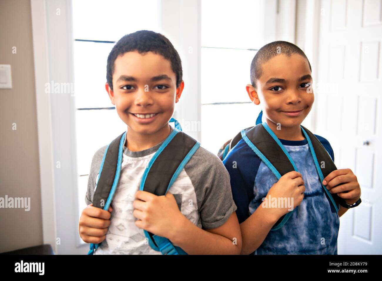 A child boy coming home passing through the door after school Stock ...