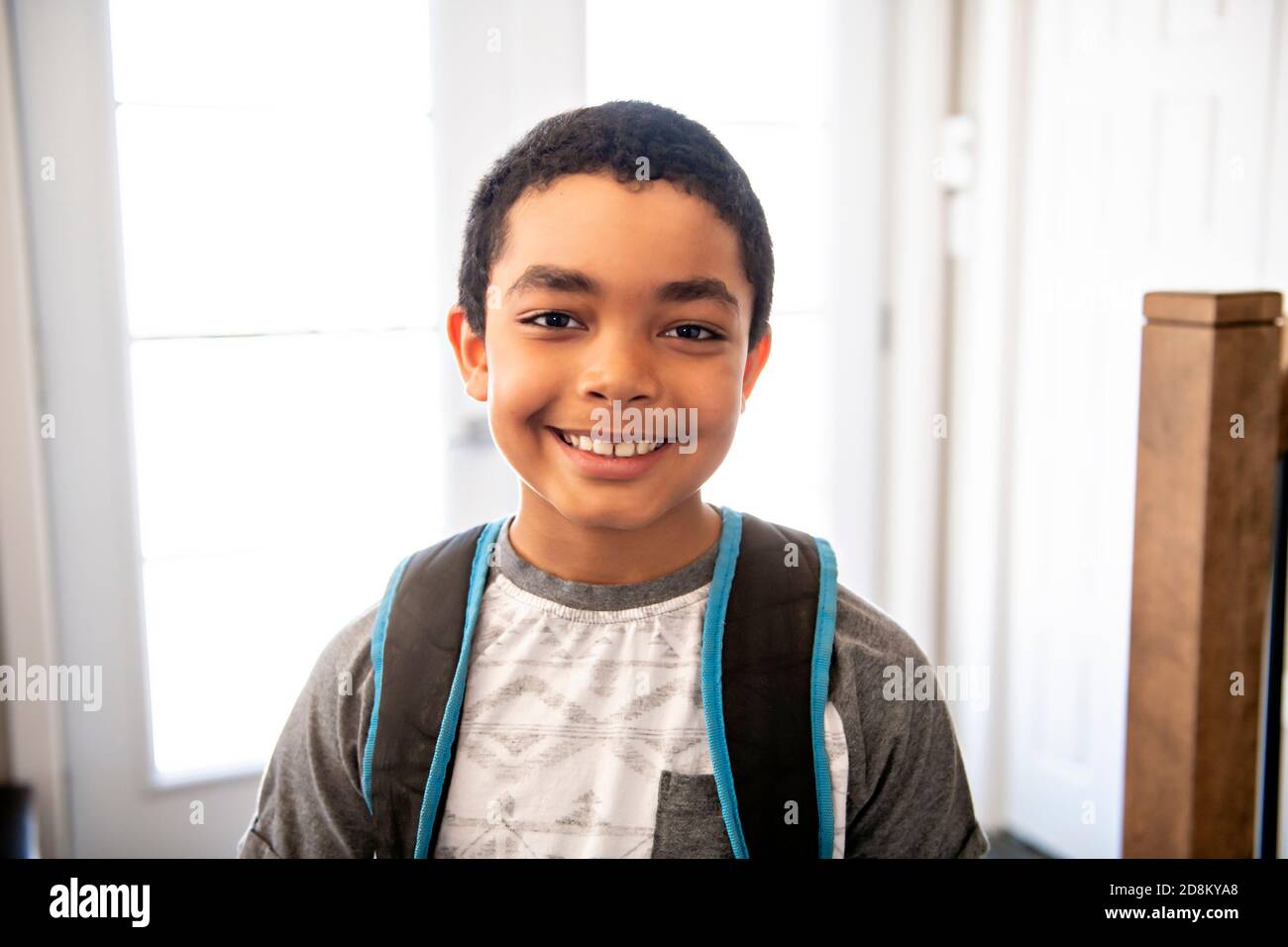 A child boy coming home passing through the door after school Stock ...