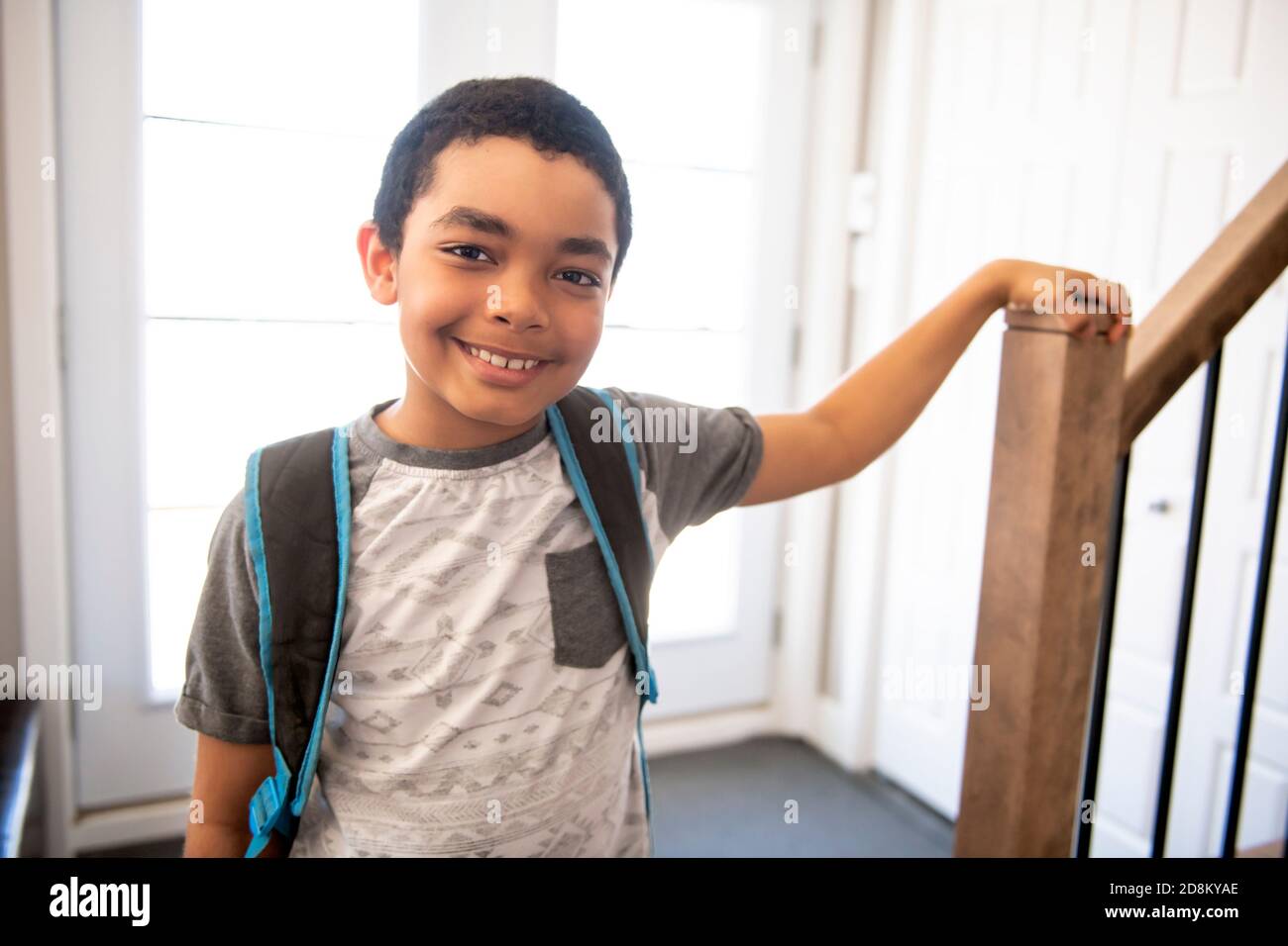 A child boy coming home passing through the door after school Stock ...