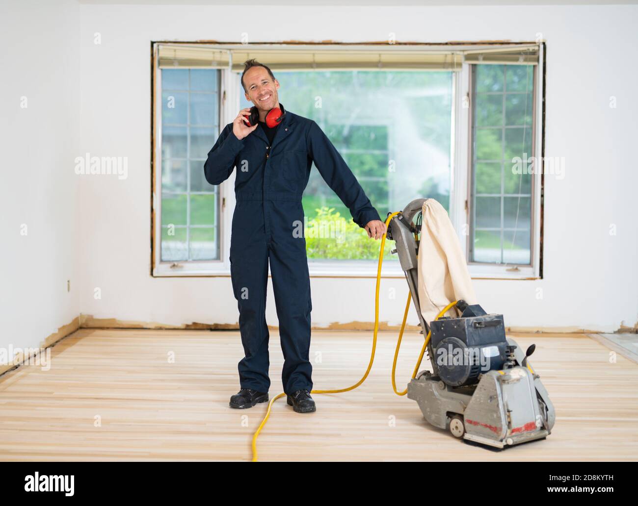 A Sanding hardwood floor with the grinding machine Stock Photo - Alamy