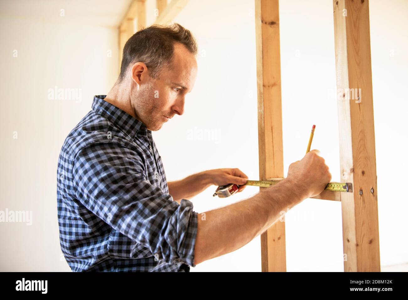 Carpenter using ruler pencil working hi-res stock photography and ...