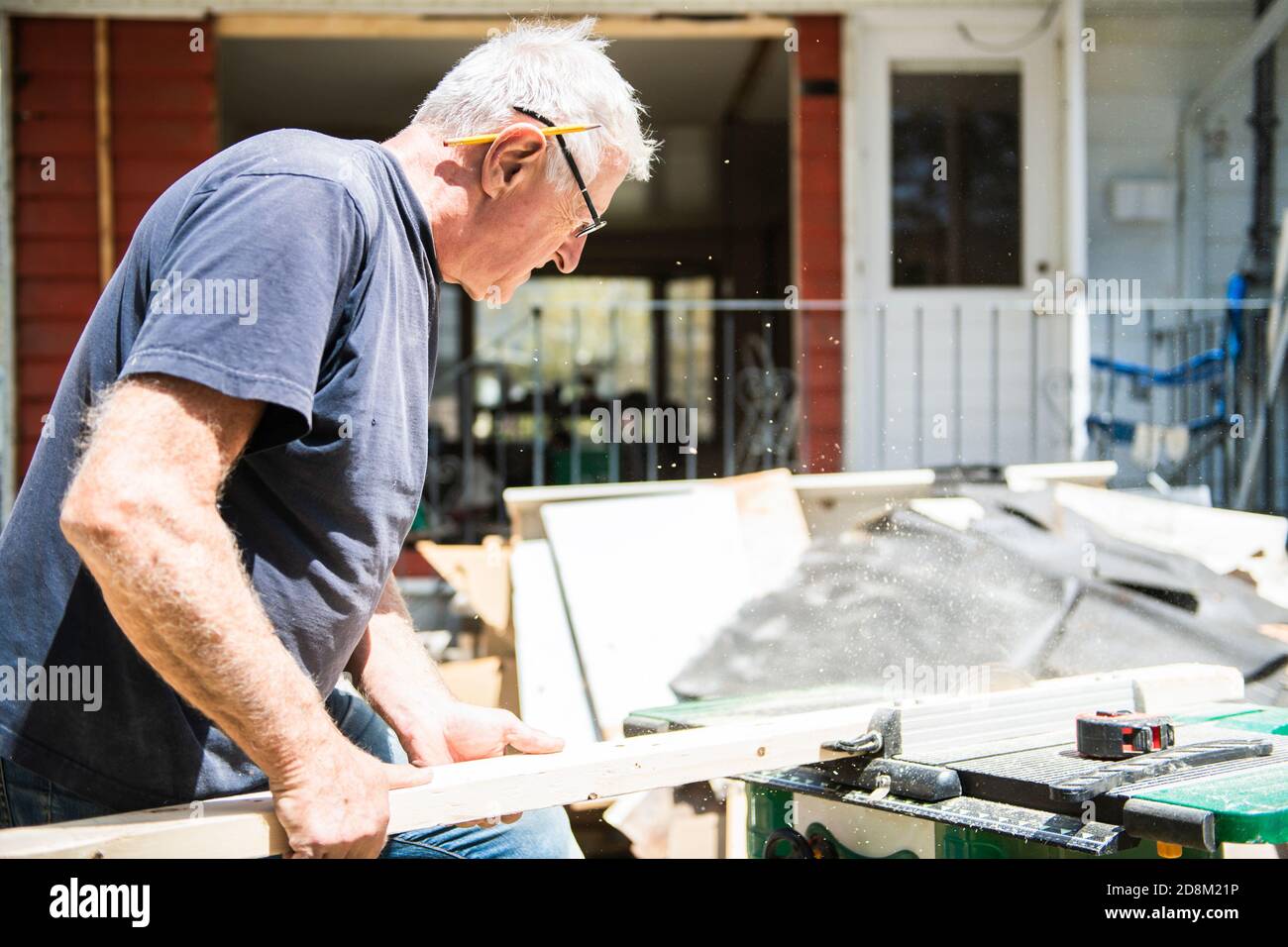 Active Older Man Working with a Saw in the Yard Stock Photo - Alamy