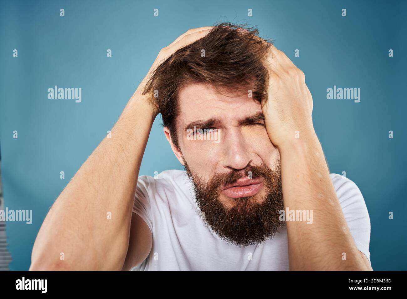 Man in white t-shirt lifestyle studio emotions facial expression blue ...