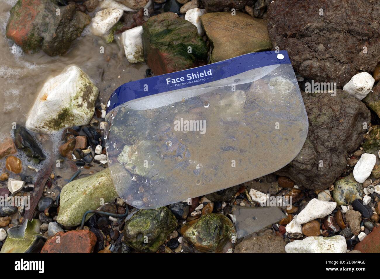 Face shield discarded and washed up on the beach causing an ...