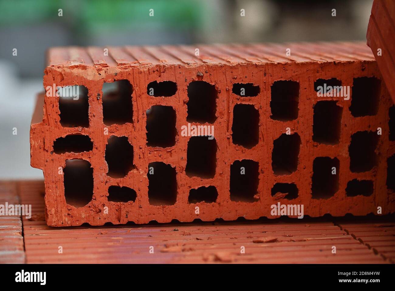 Red hollow wall brick. The pile of red hollow bricks lit. Material for ...