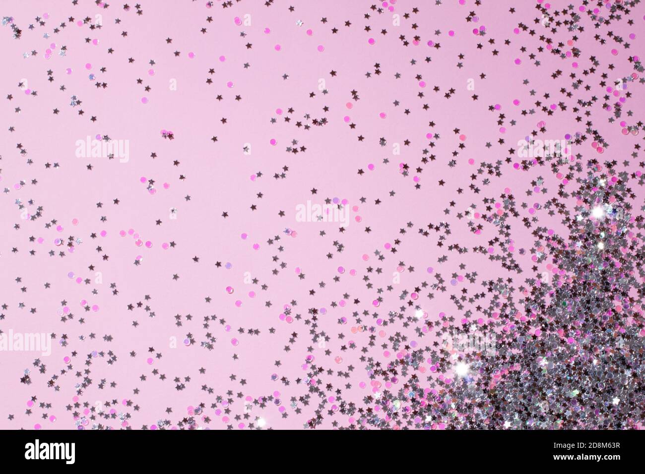 Pink sequins on a pink pastel background with confetti as asterisks ...