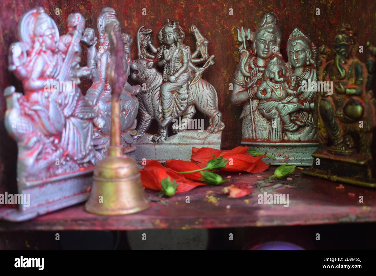 Small silver holly god statue on Worship room Stock Photo - Alamy