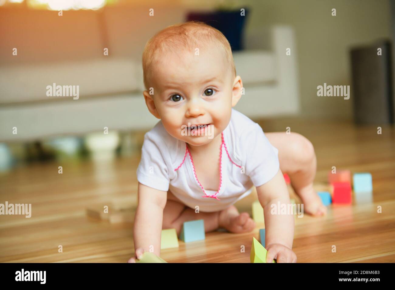 A crawling funny baby indoors at home play with block Stock Photo - Alamy