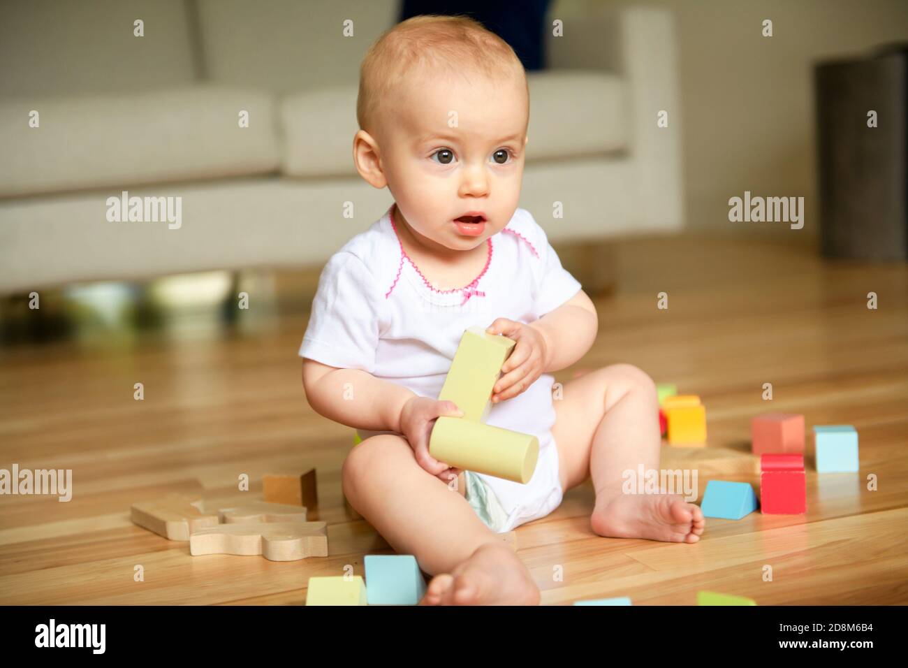 A crawling funny baby indoors at home play with block Stock Photo - Alamy