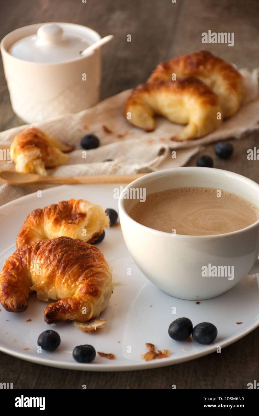 Perfect morning breakfast - freshly baked croissants, a cup of coffee ...
