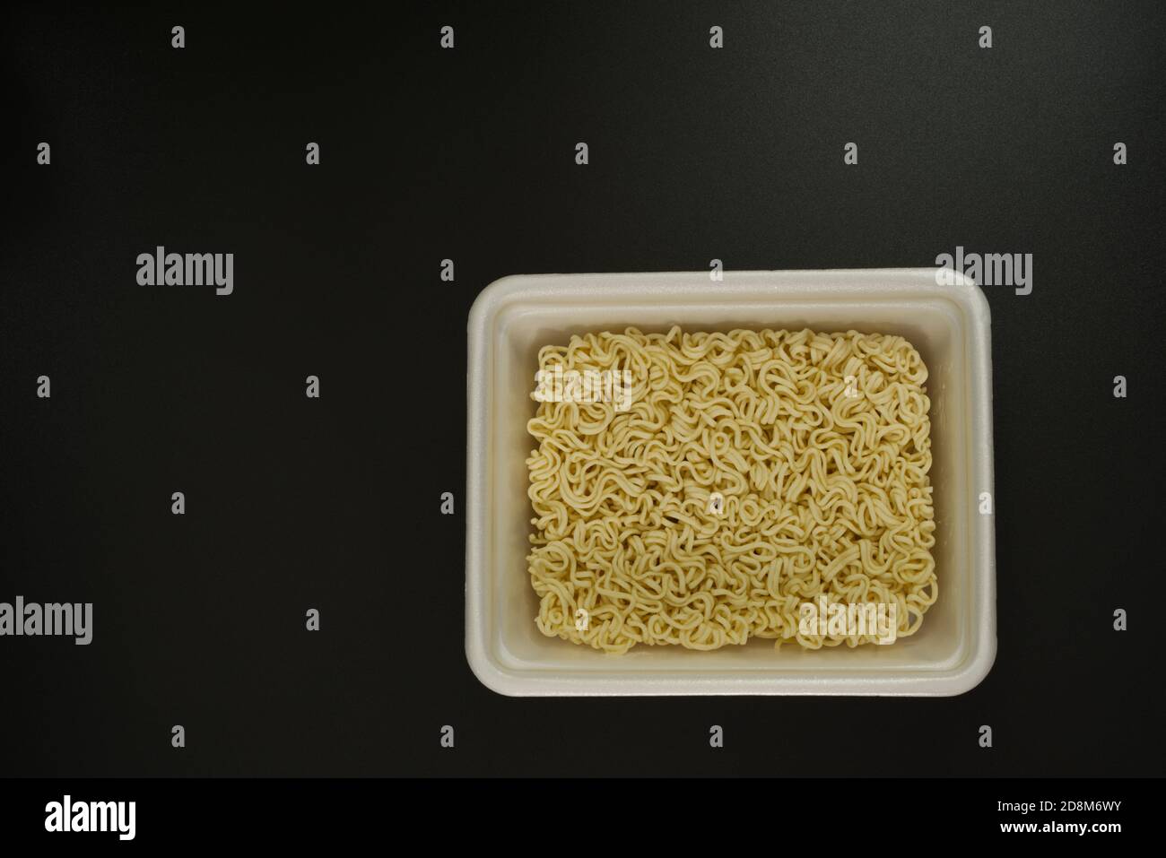 Dry instant noodles in rectangle plastic plate, top view Stock Photo ...