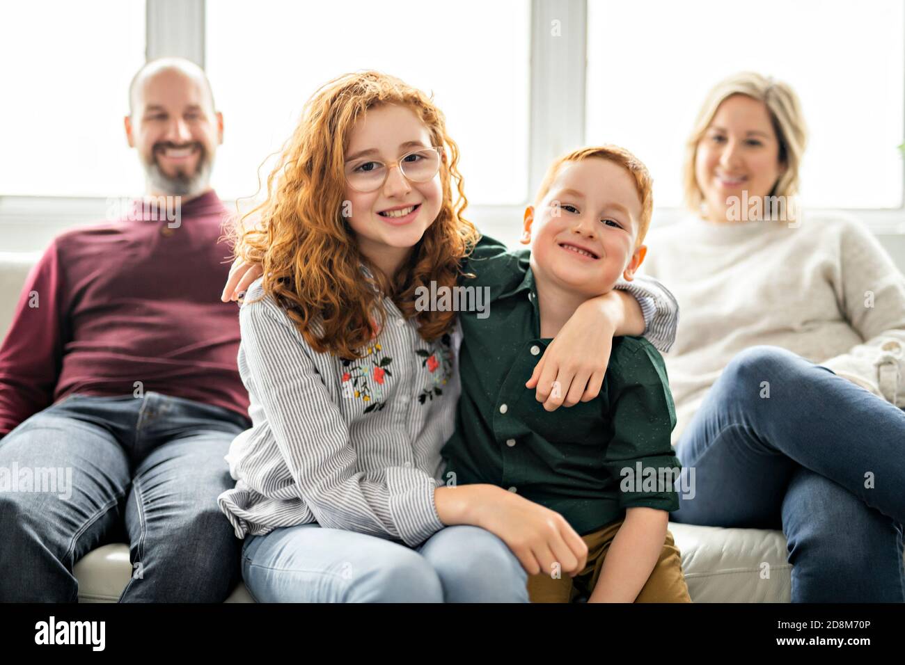 A Beautiful happy family having fun on sofa at home Stock Photo - Alamy