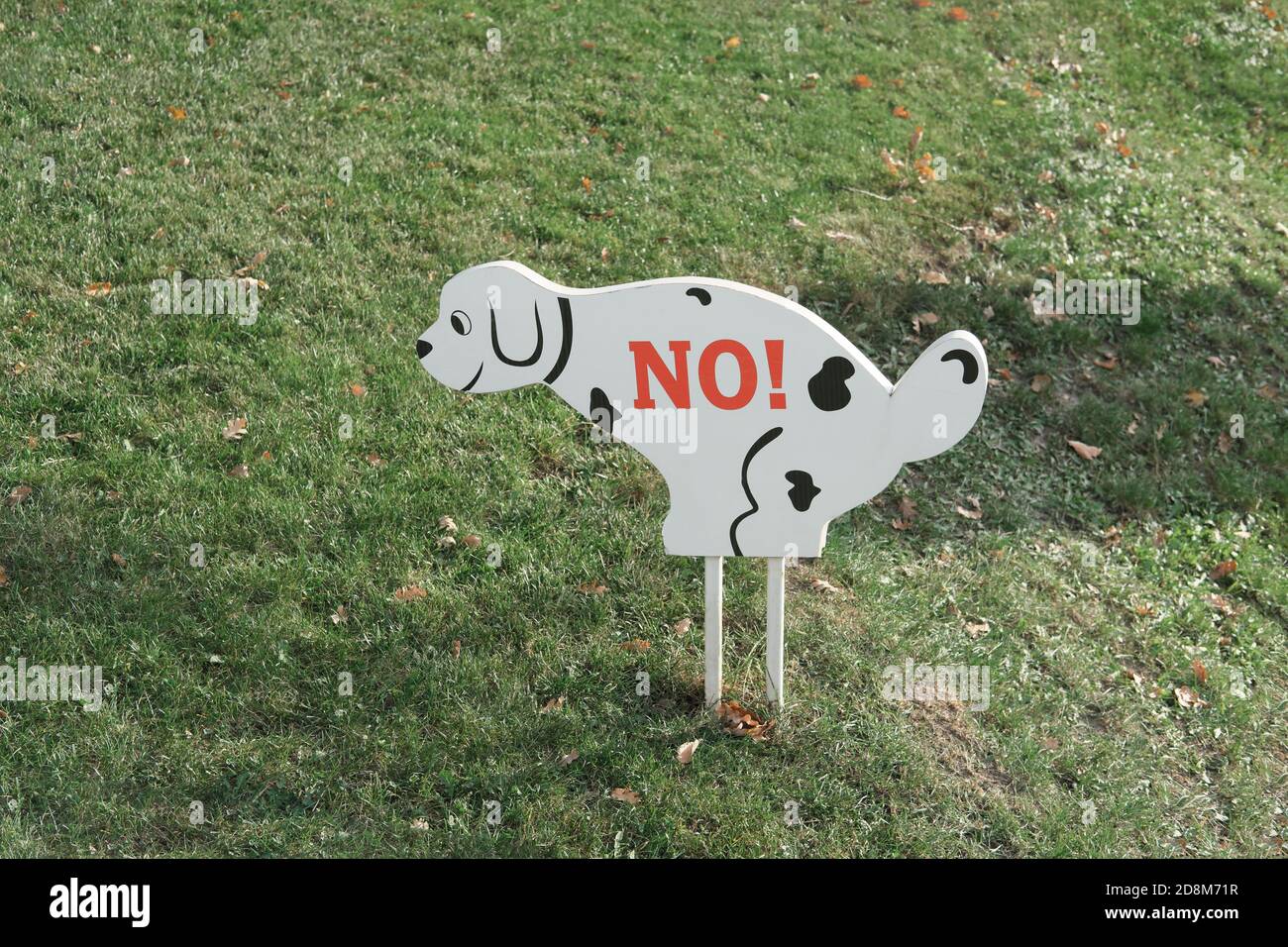 no dog toilet sign on a lawn. symbol of dog pooping prohibition. white ...