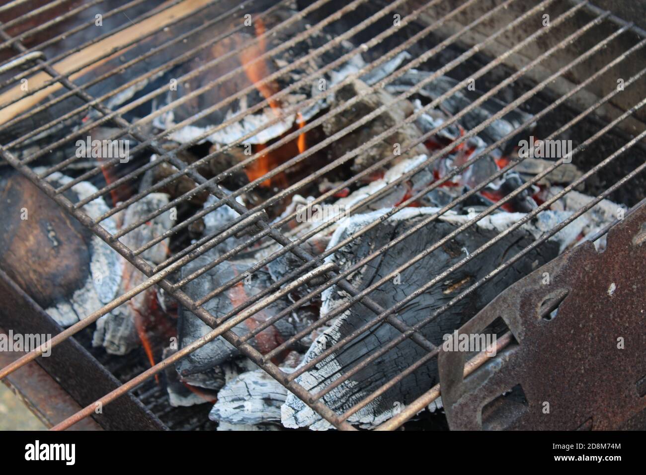 Closeup shot of burning firewood on the grill Stock Photo - Alamy