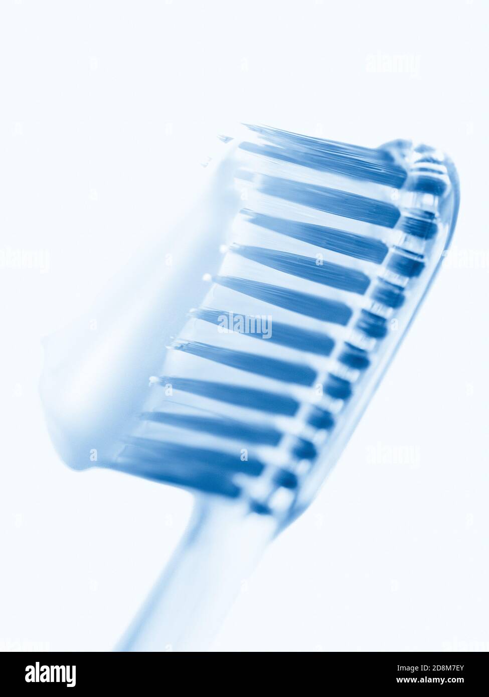 Two blue plastic toothbrushes with toothpaste on white art background ...