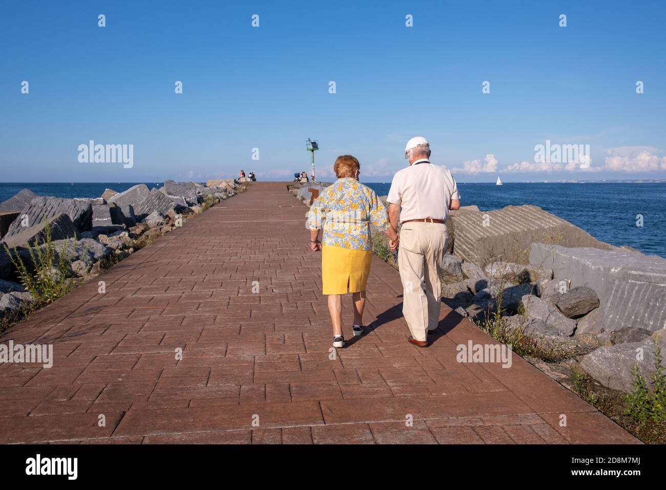 Senior couple walking by the sea. Aged people with a healthy lifestyle ...
