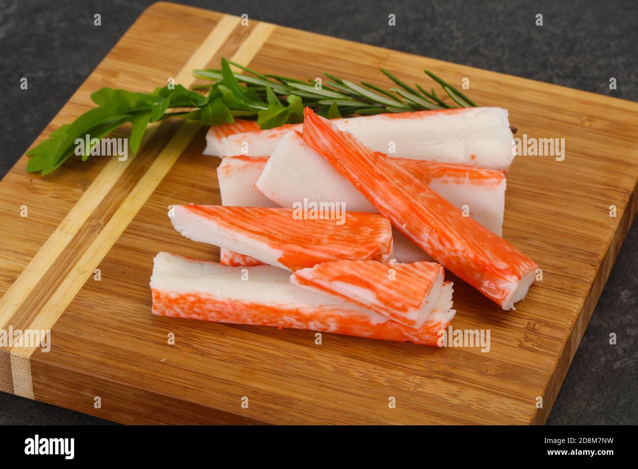 Crab stick surimi over wooden board Stock Photo - Alamy