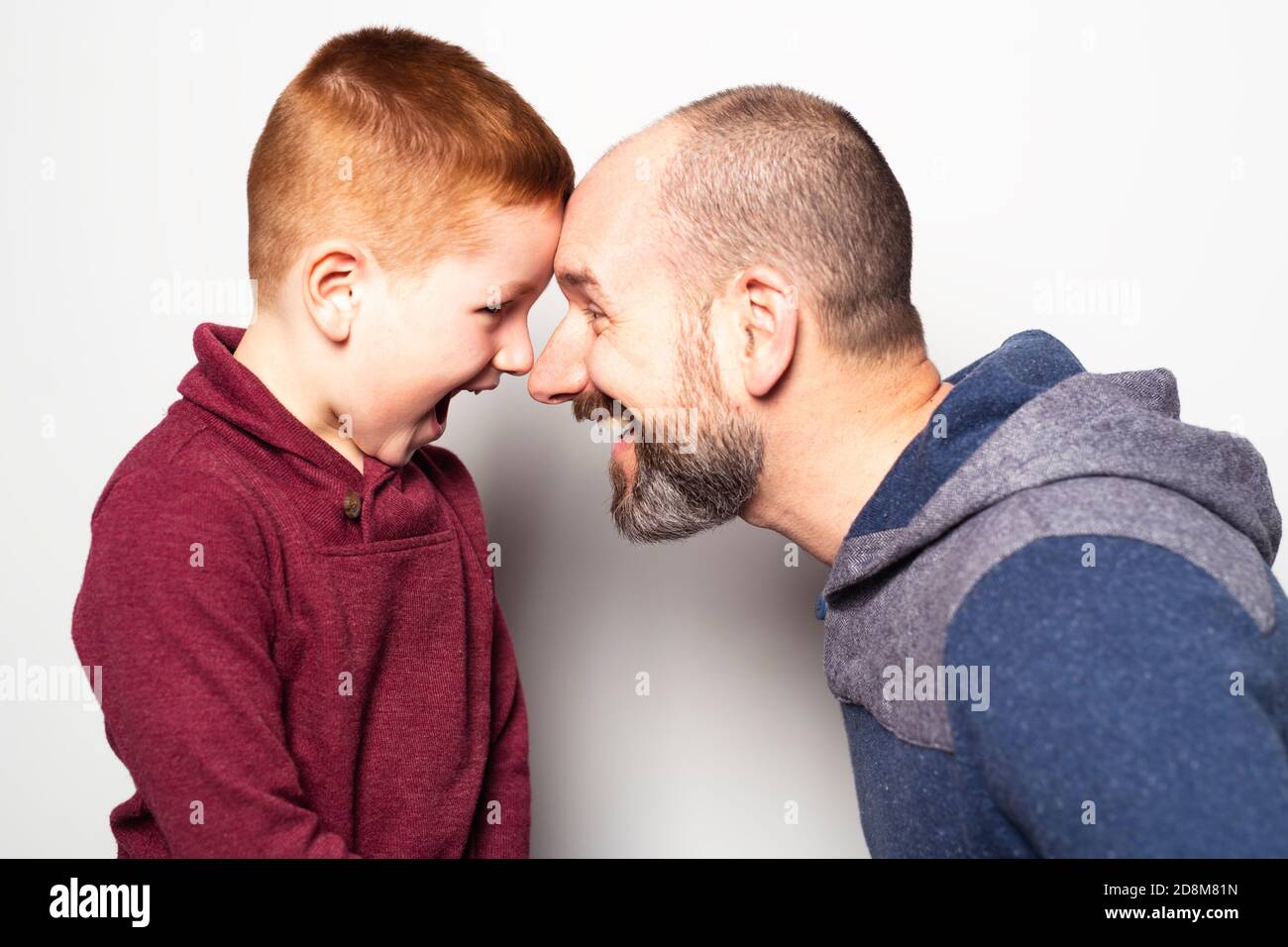 cheerful redhead father and son and smiling at camera isolated on white ...