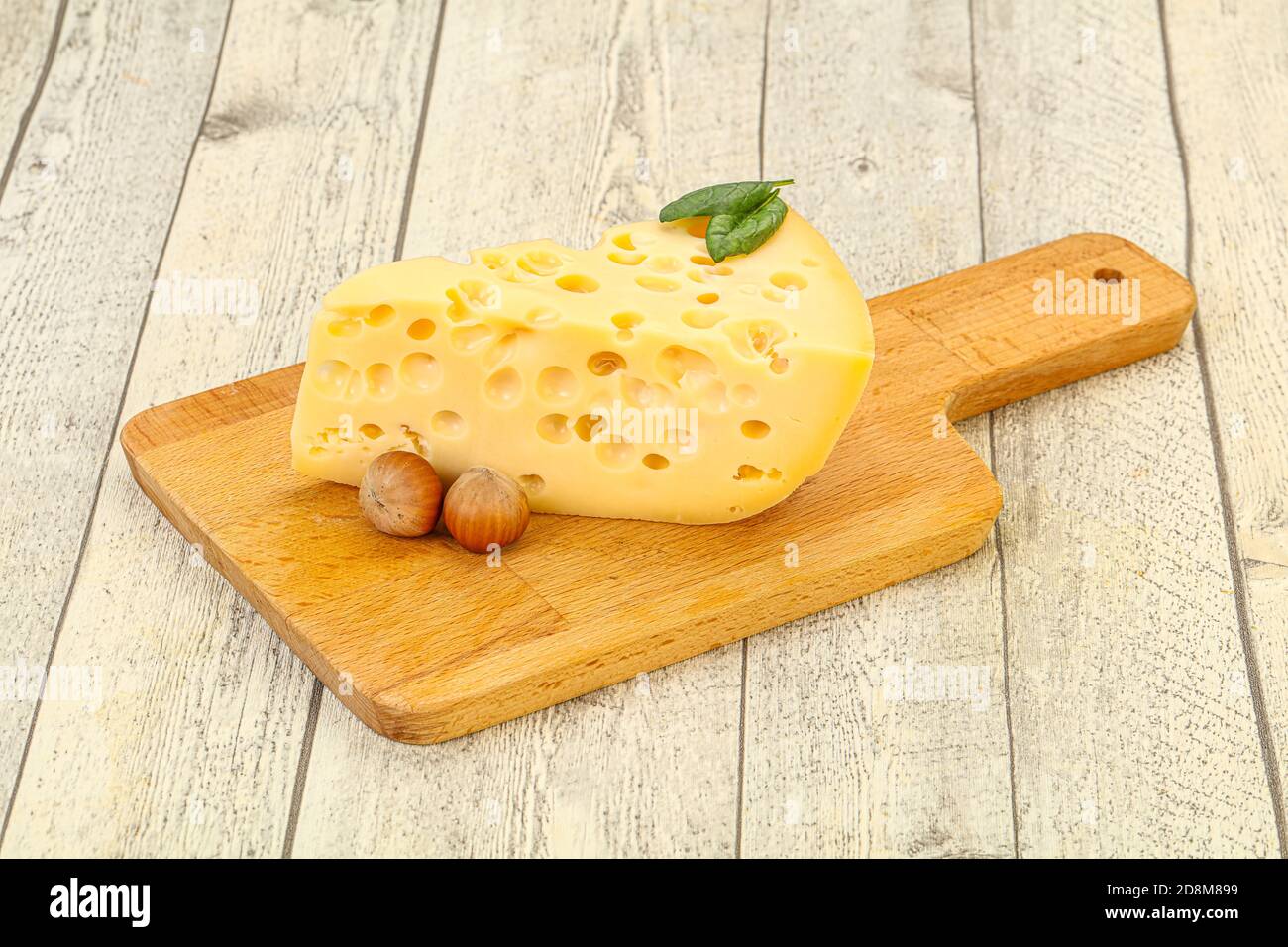 Maasdam cheese - dairy yellow triangle with holes Stock Photo - Alamy