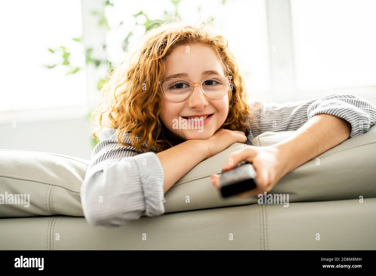 Child watching television remote hi-res stock photography and images ...