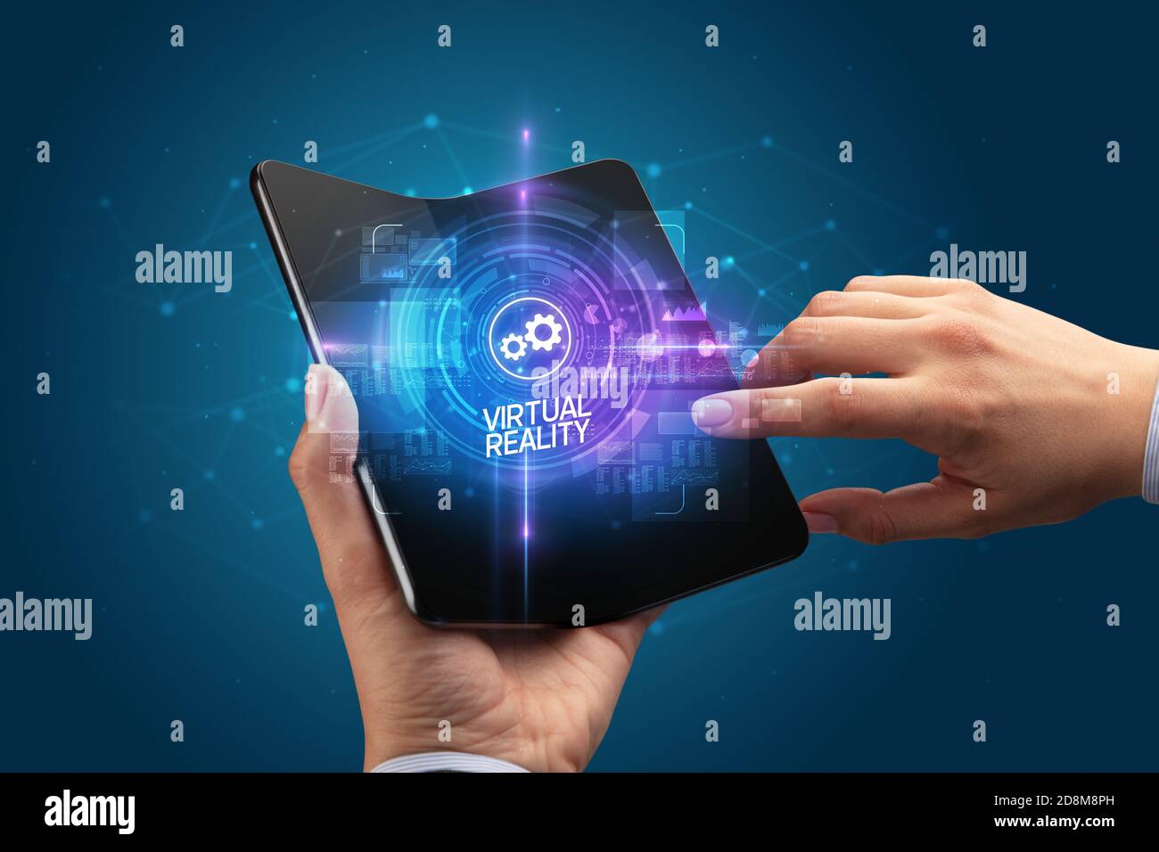 Businessman holding a foldable smartphone with BLOCKCHAIN inscription ...