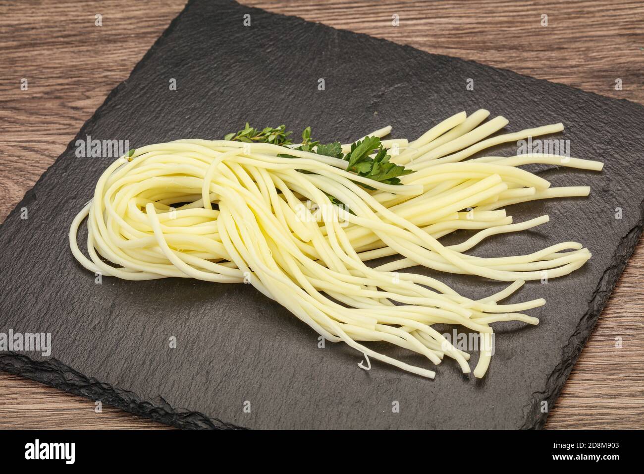 Chechil spaghetti cheese snack over board Stock Photo - Alamy