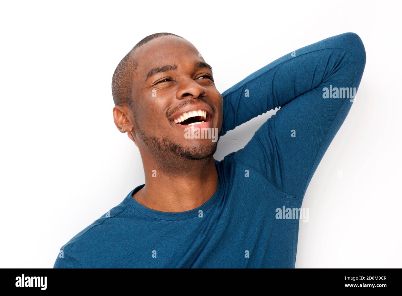 Close up portrait of handsome young black man laughing with hand behind ...
