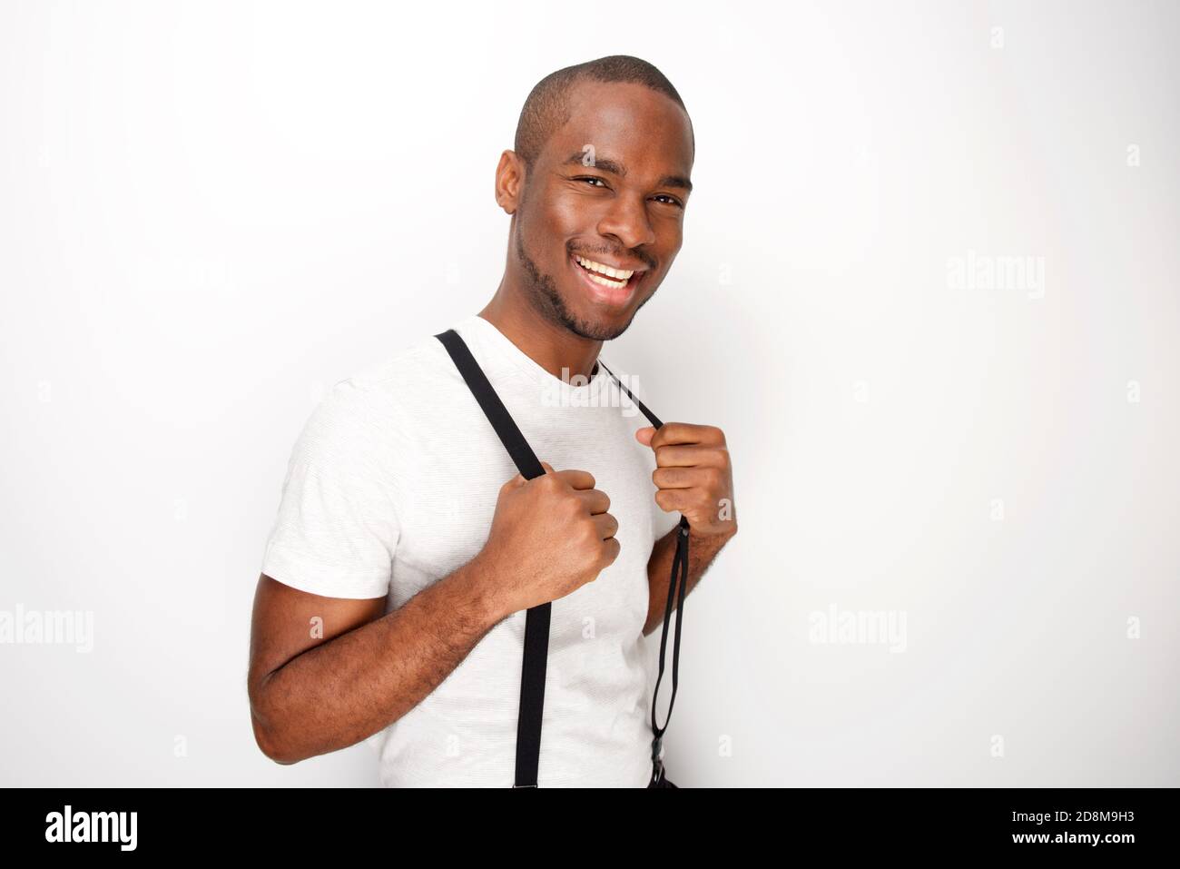 Side portrait of happy african american man posing with suspenders by ...