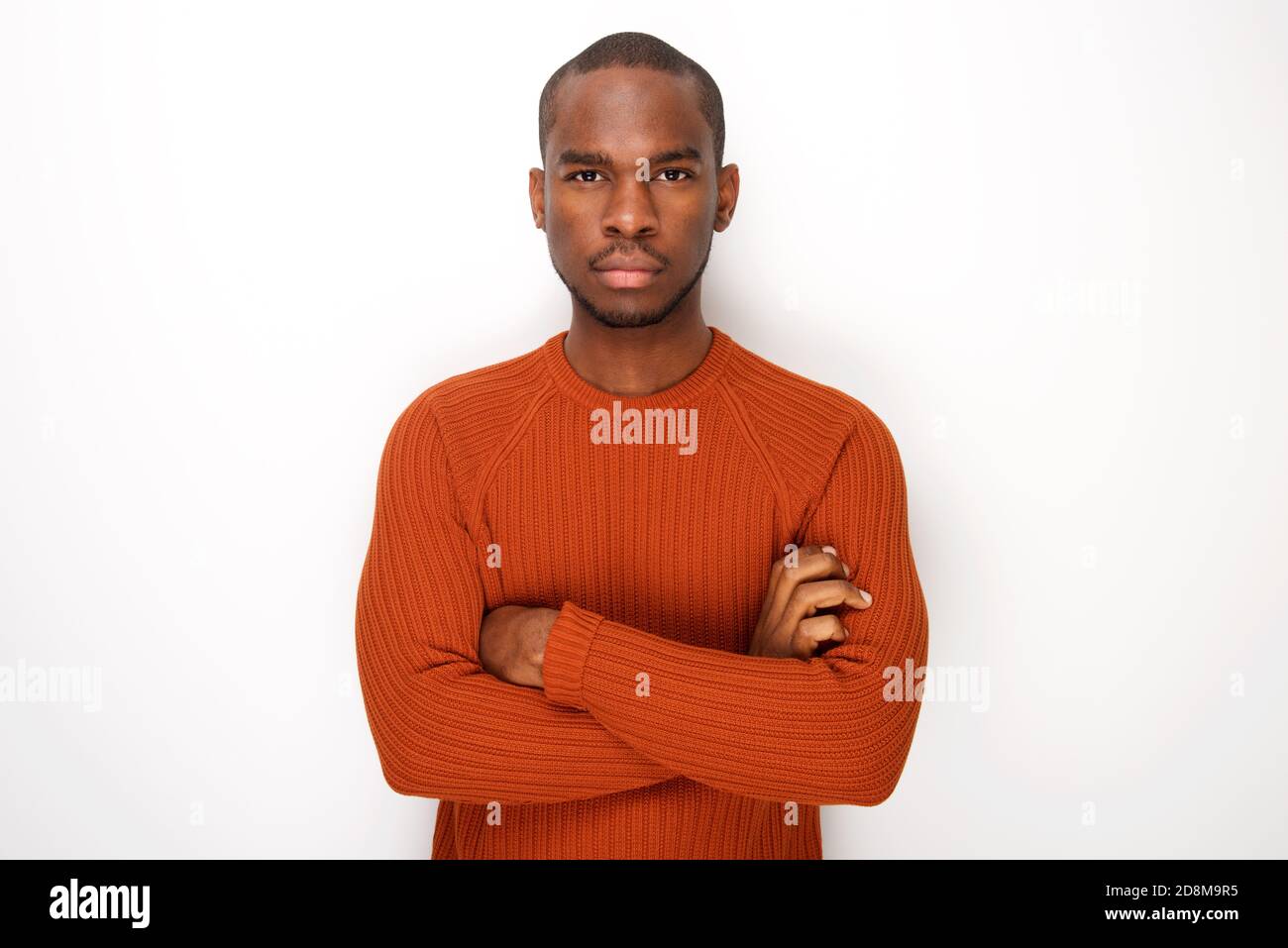 Front portrait of serious african american man with arms crossed posing ...